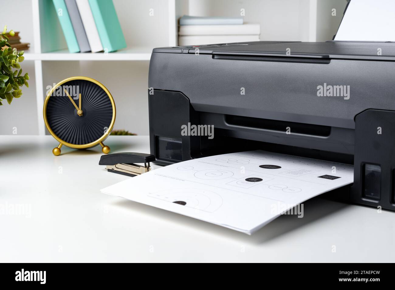 Workplace with modern printer and clock in the office Stock Photo - Alamy