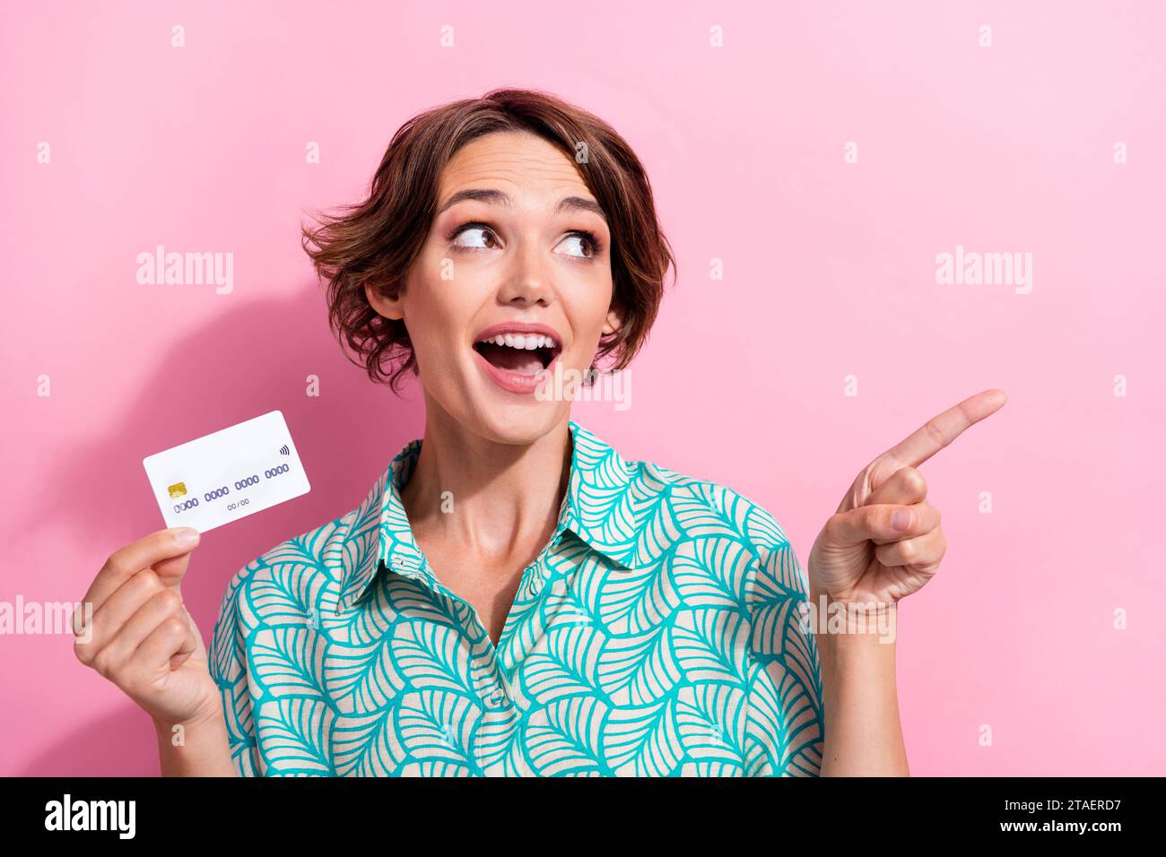 Portrait of astonished attractive lady hold debit card look direct ...