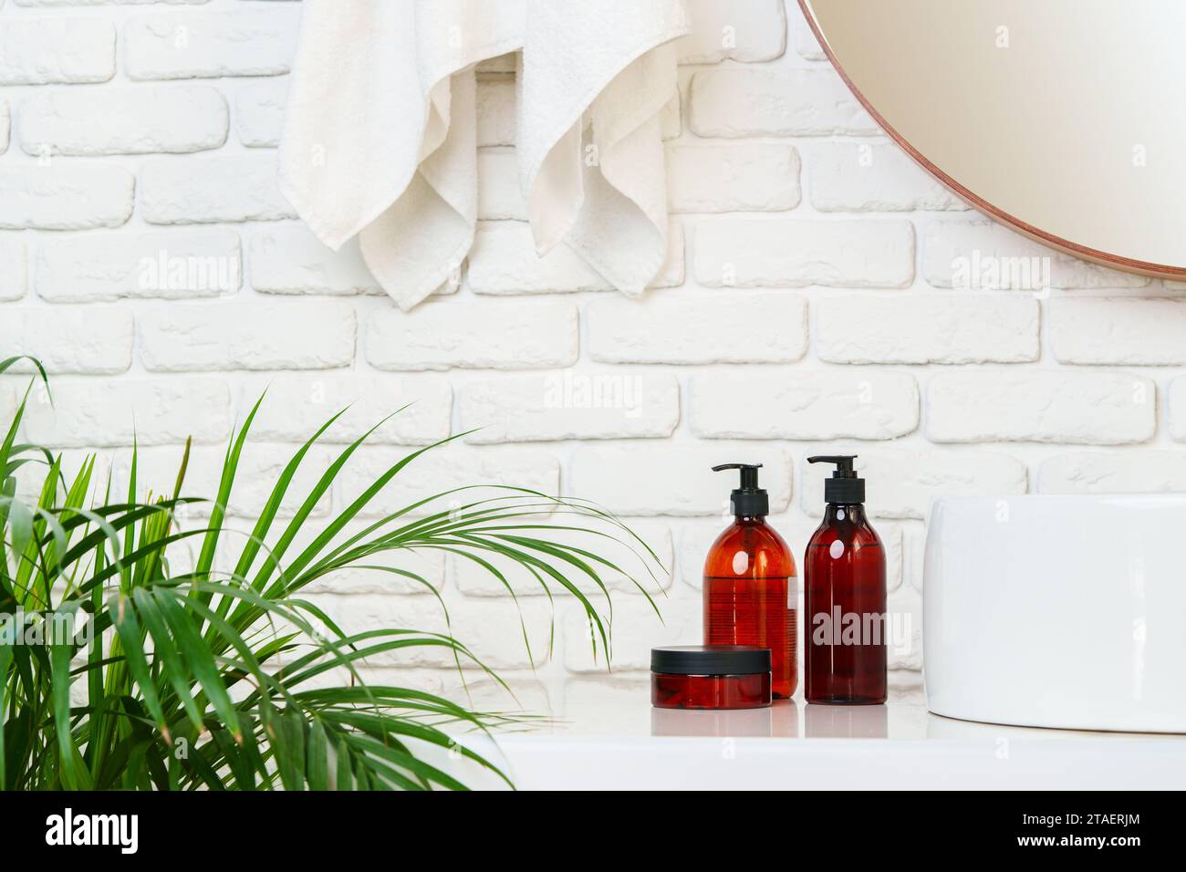 Soap and cream dispenser jars near the sink in a bathroom Stock Photo ...