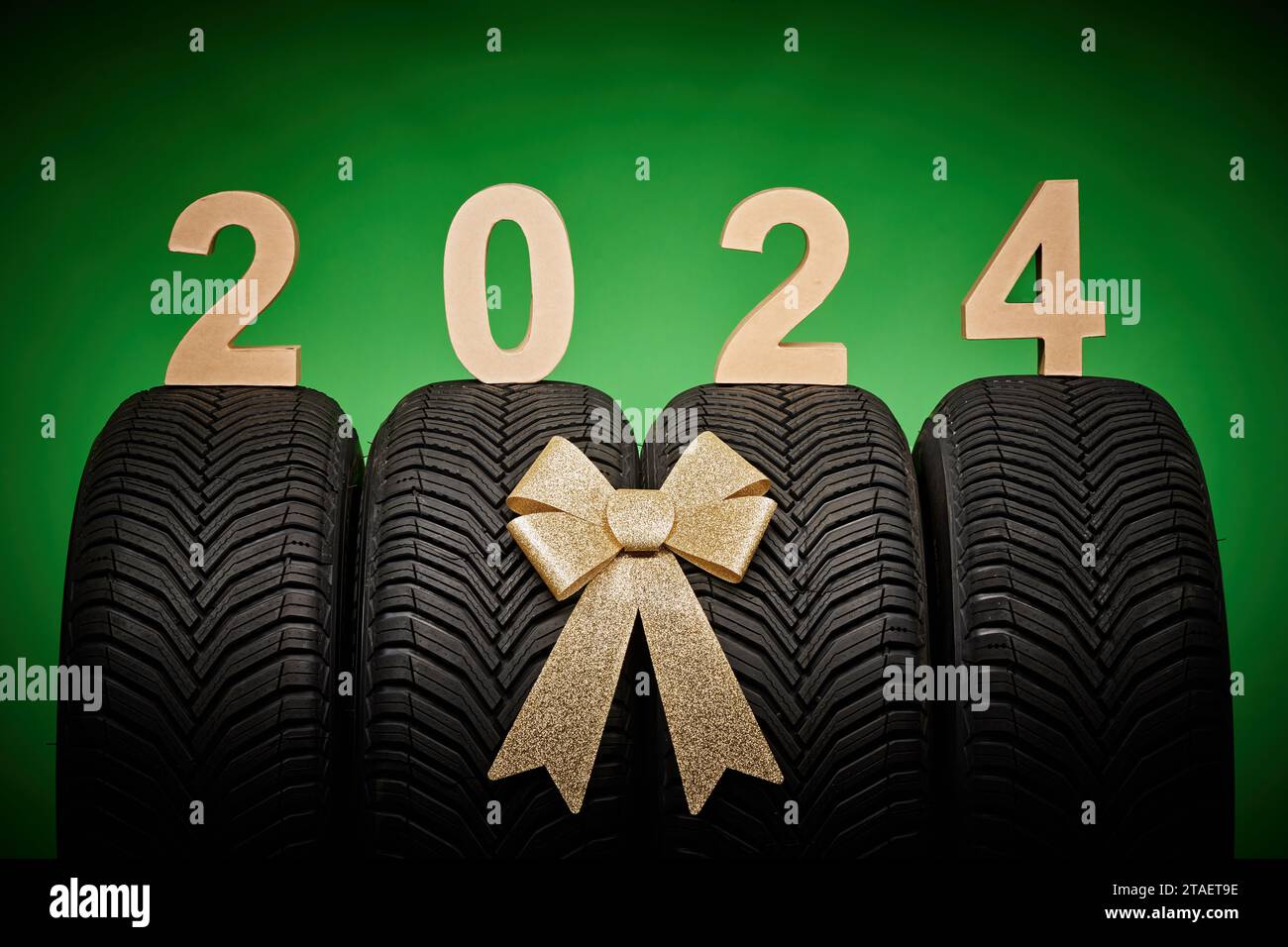 Car tires, new tyres, winter wheels isolated on green background with ...