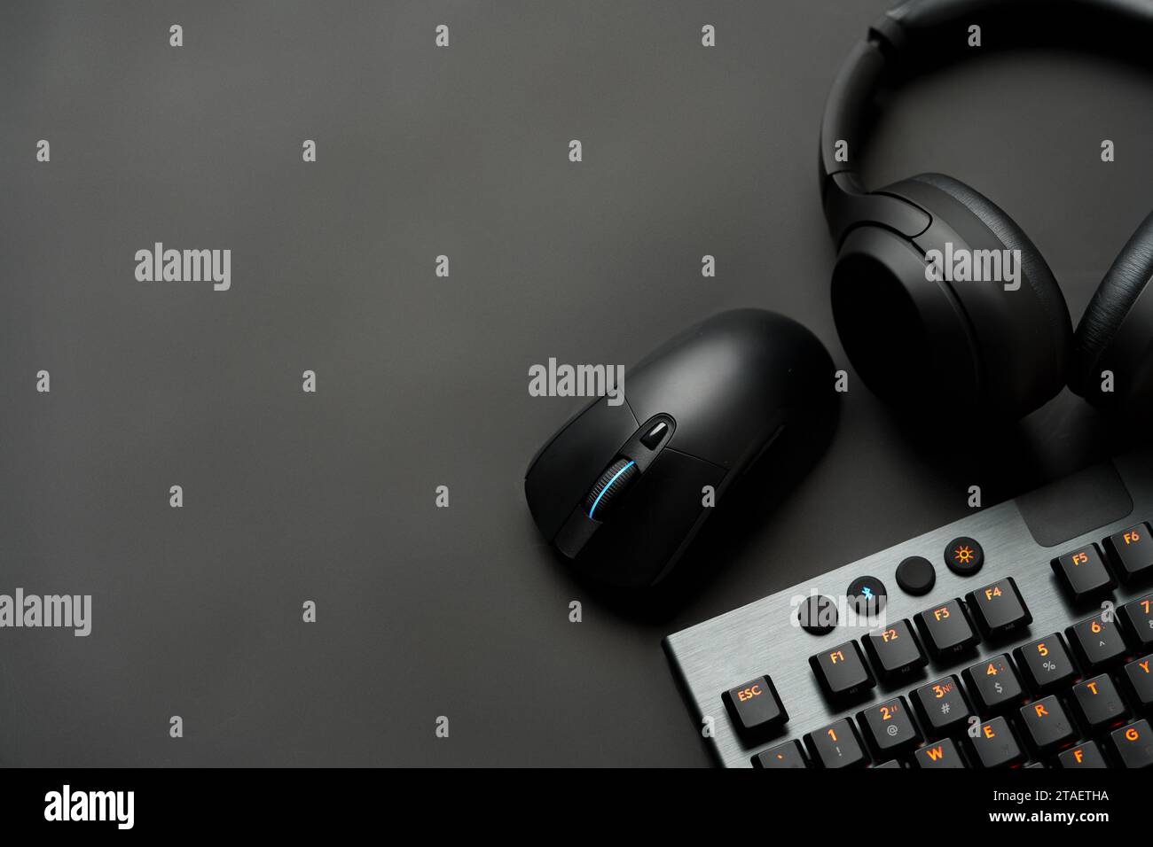 Headphones, computer mouse and keyboard on black background Stock Photo ...