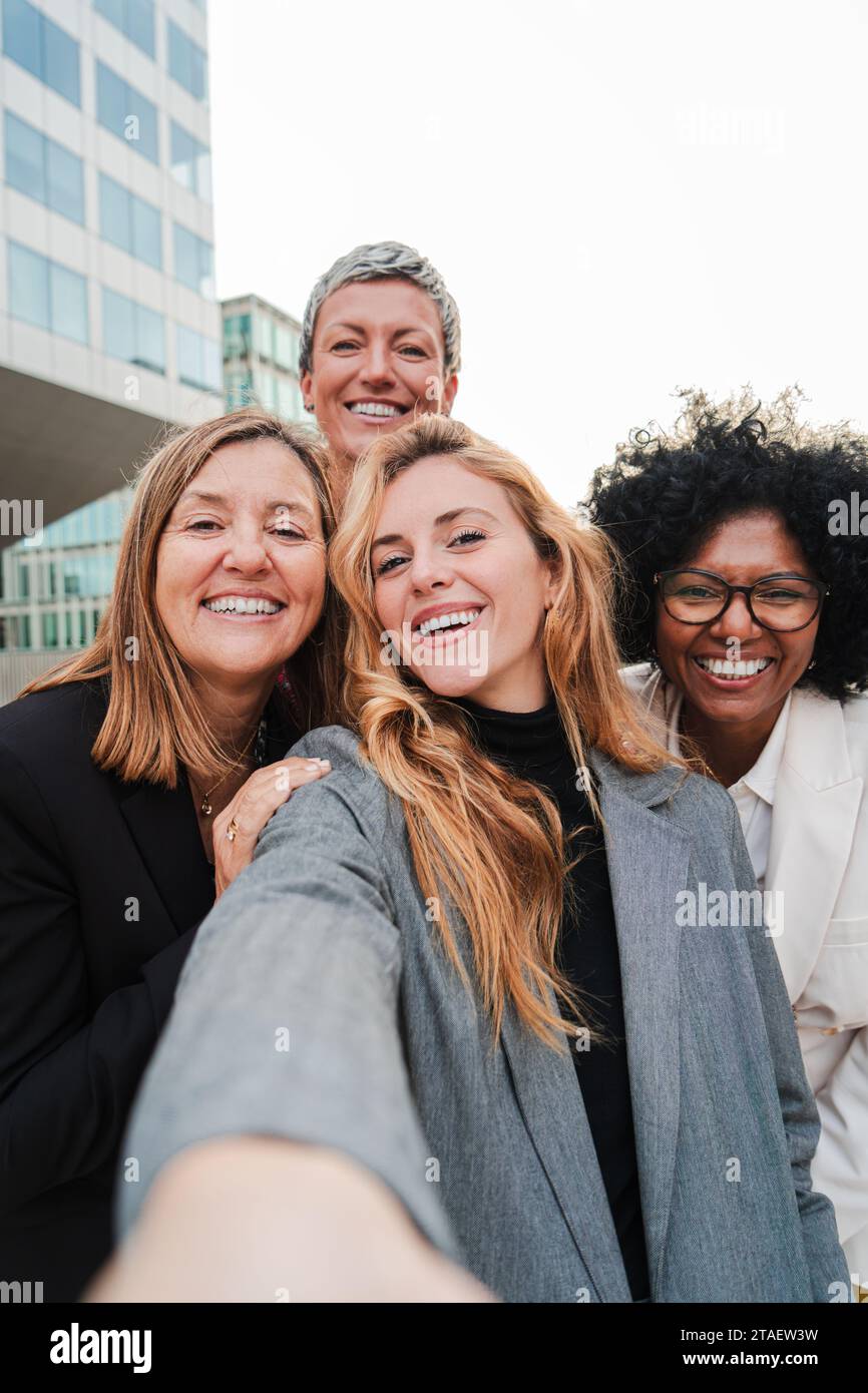 Vertical portrait. Group of real successful business woman smiling and ...