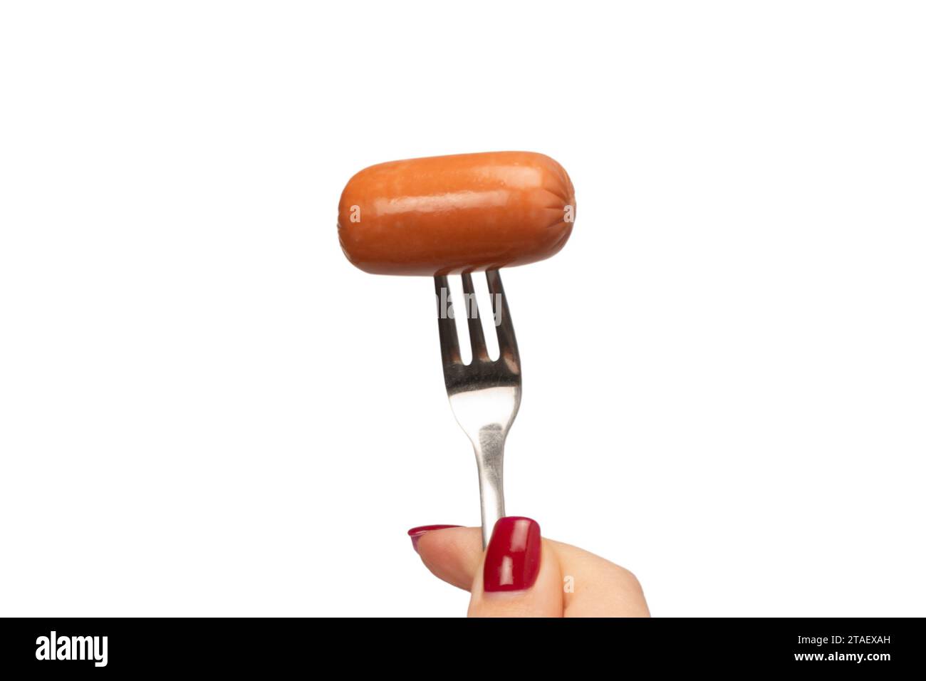 Small sausage on a fork in woman hand isolated on a white background ...