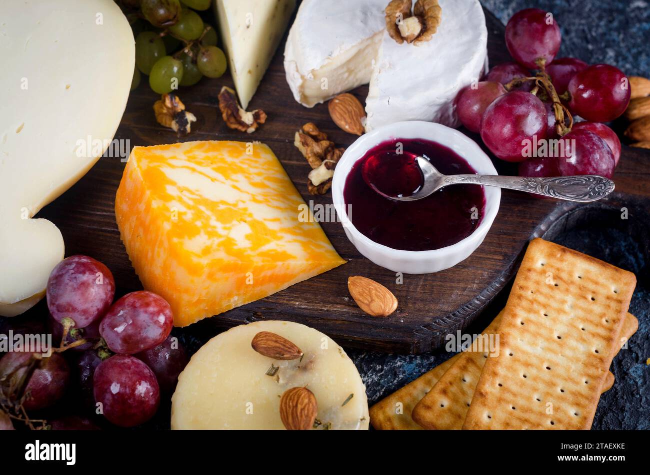 Assorted homemade pieces cheese with jam, grapes, cookies and nuts ...