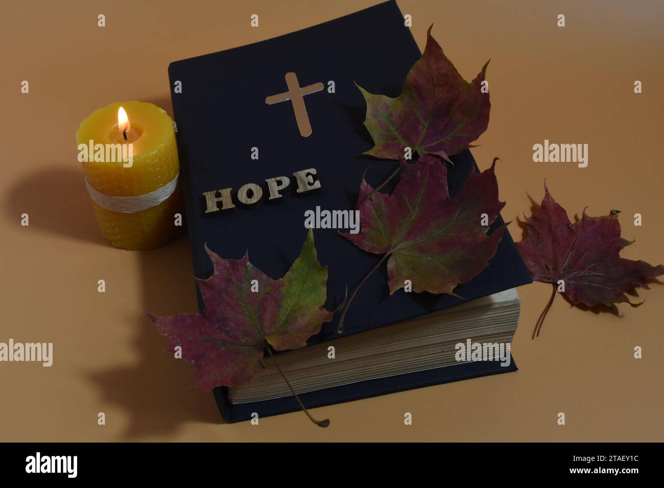 Holy bible, advent candle. Advent concept. Maple leaves Stock Photo - Alamy