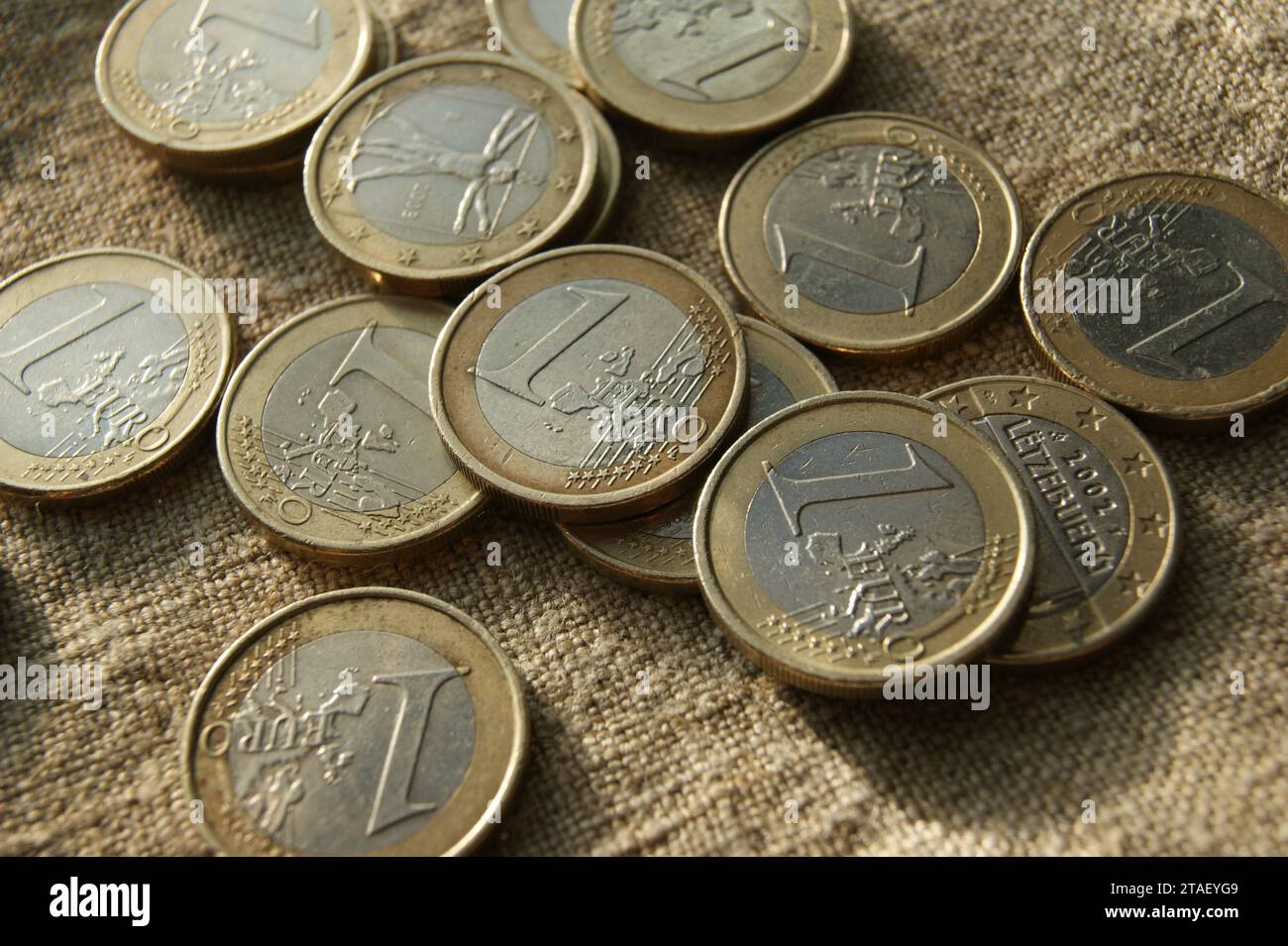 1 euro coins on natural linen fabric. Bimetallic European coins Stock ...