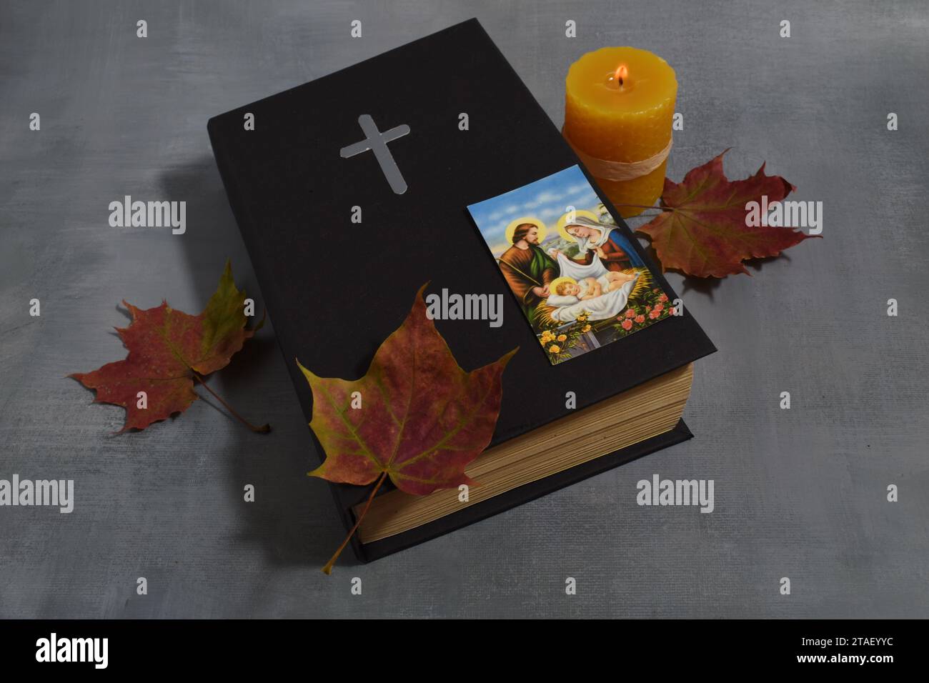 Holy bible, advent candle. Advent concept. Maple leaves Stock Photo - Alamy