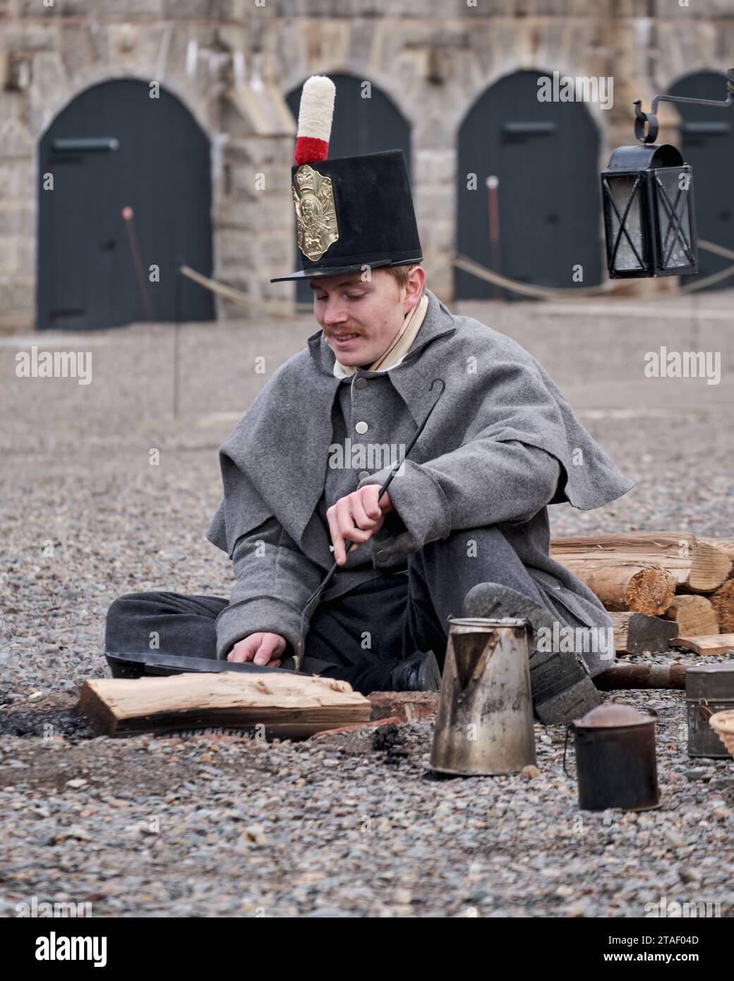 reenactment of Canadian soldier from Victorian era cooking meal on open ...