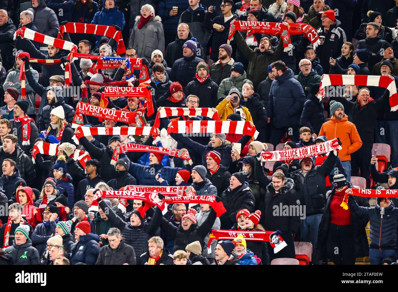 Liverpool, UK. 30th Nov, 2023. Liverpool fans hold up scarves and sing ...