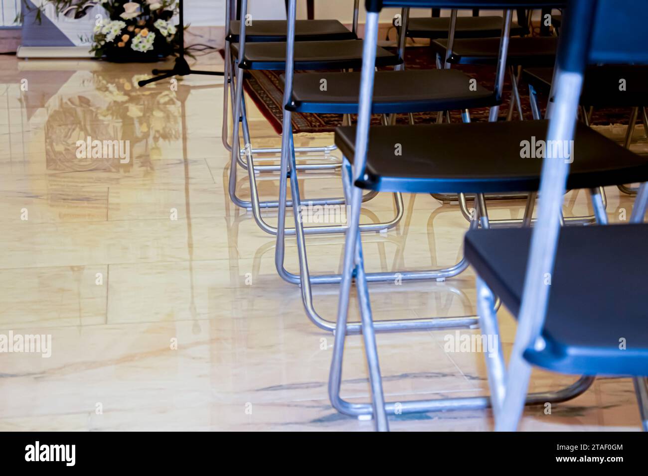 Set of empty wooden chairs lined up before an event in an ancient ...