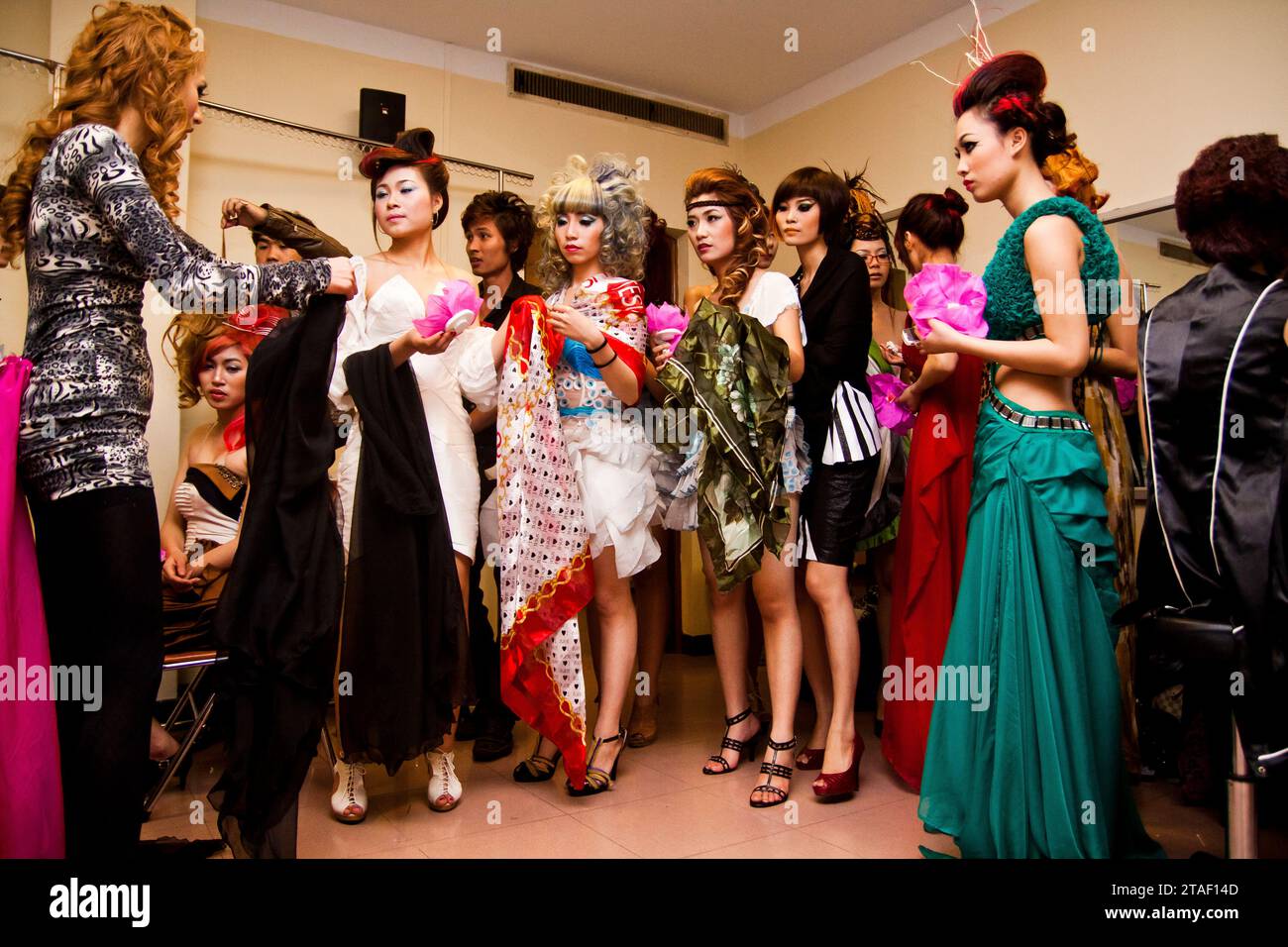 Models line up for costume parts backstage at a show in Hanoi, Vietnam ...