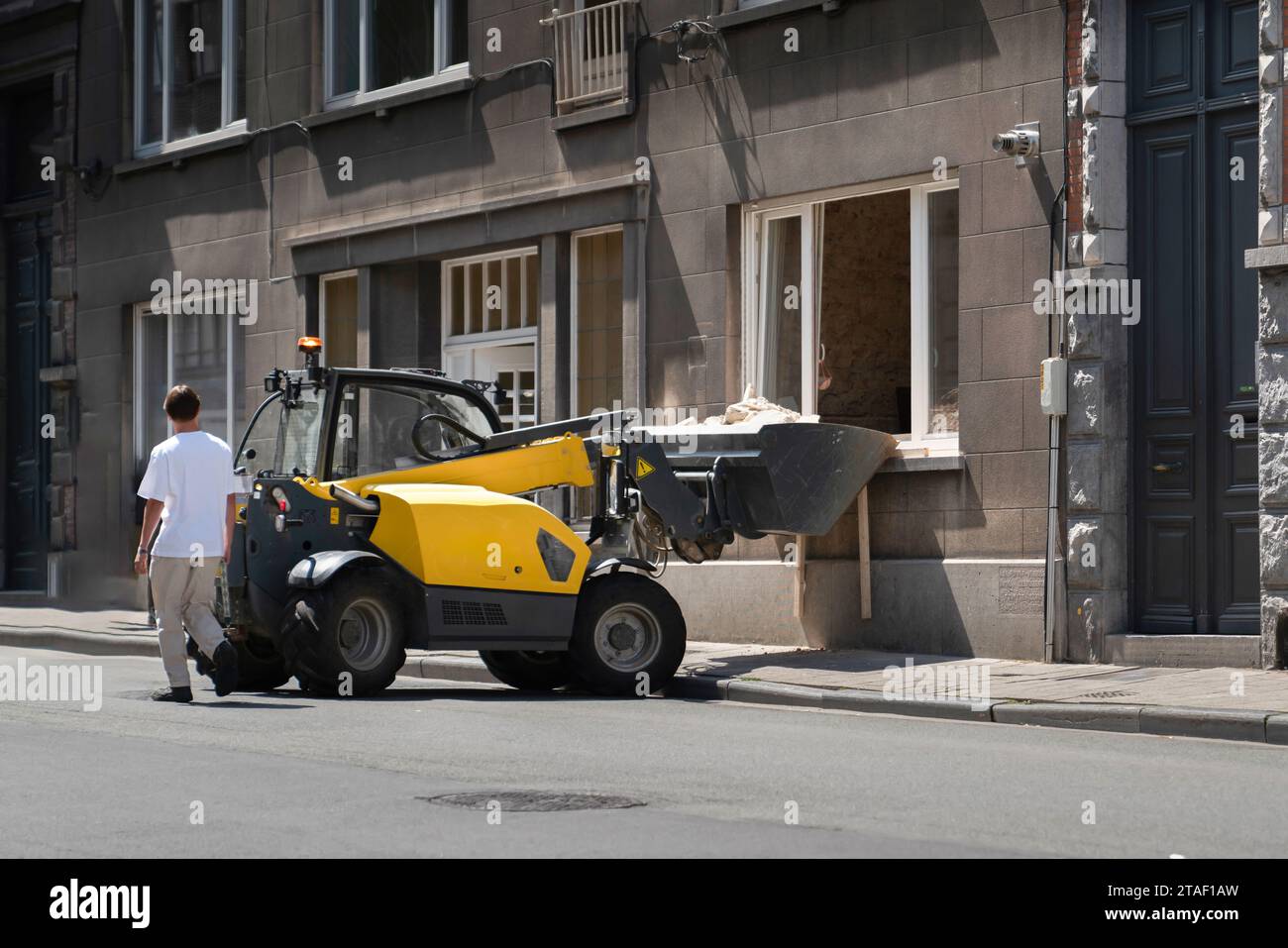 The rubble from apartment renovations is collected in the bucket of a ...