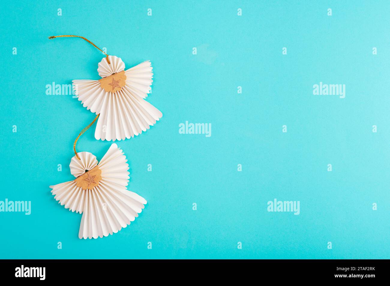 Paper angels on blue background. Christmas concept. Top view, flat lay ...