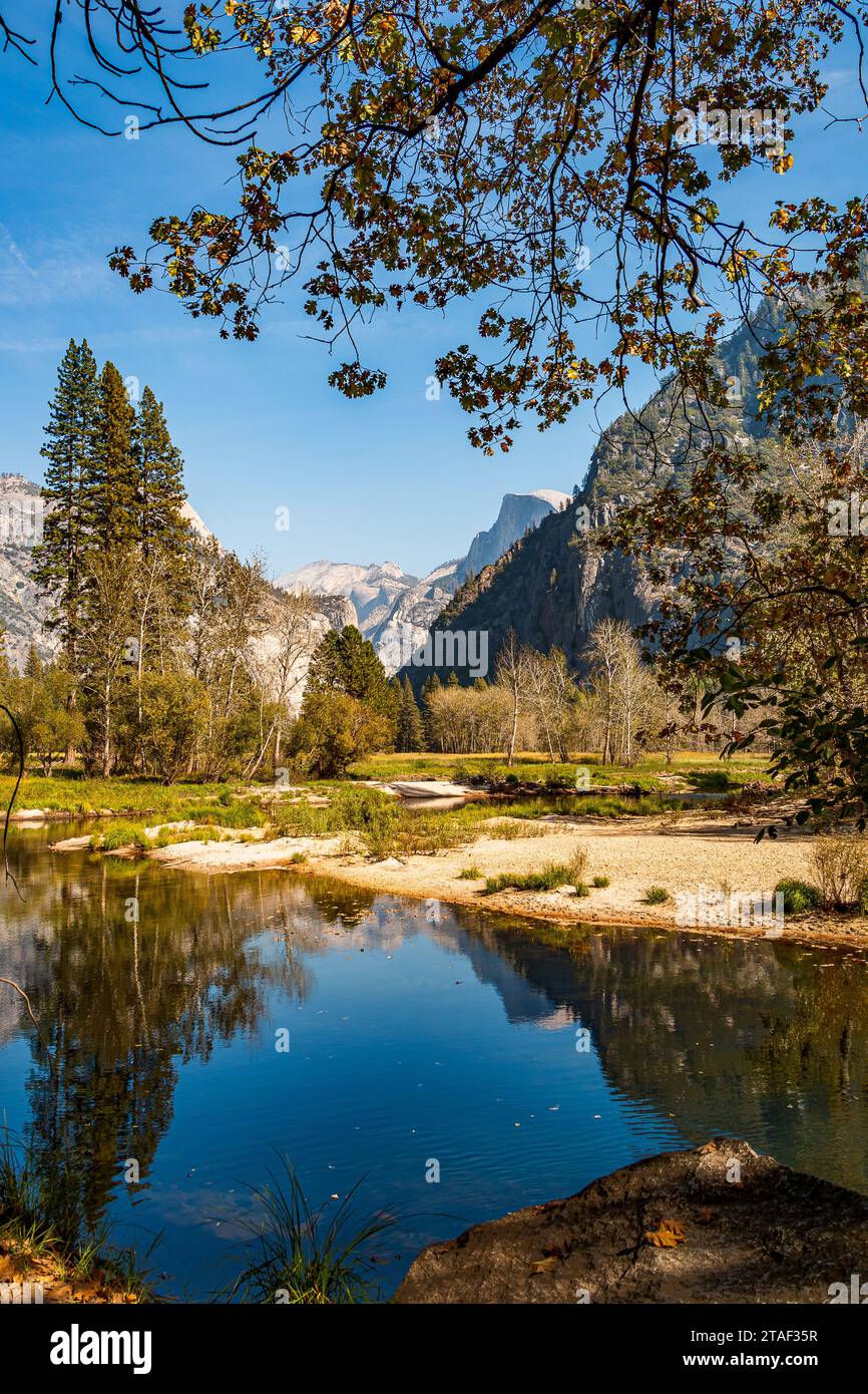 Sunny vertical landscape scene of the Merced river with a reflection in ...