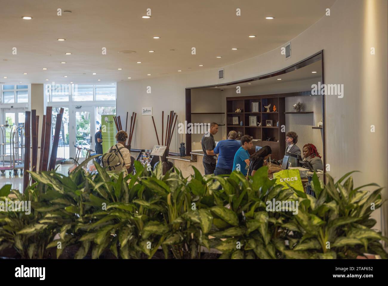 Beautiful contemporary Radisson Hotel interior with guests at reception ...
