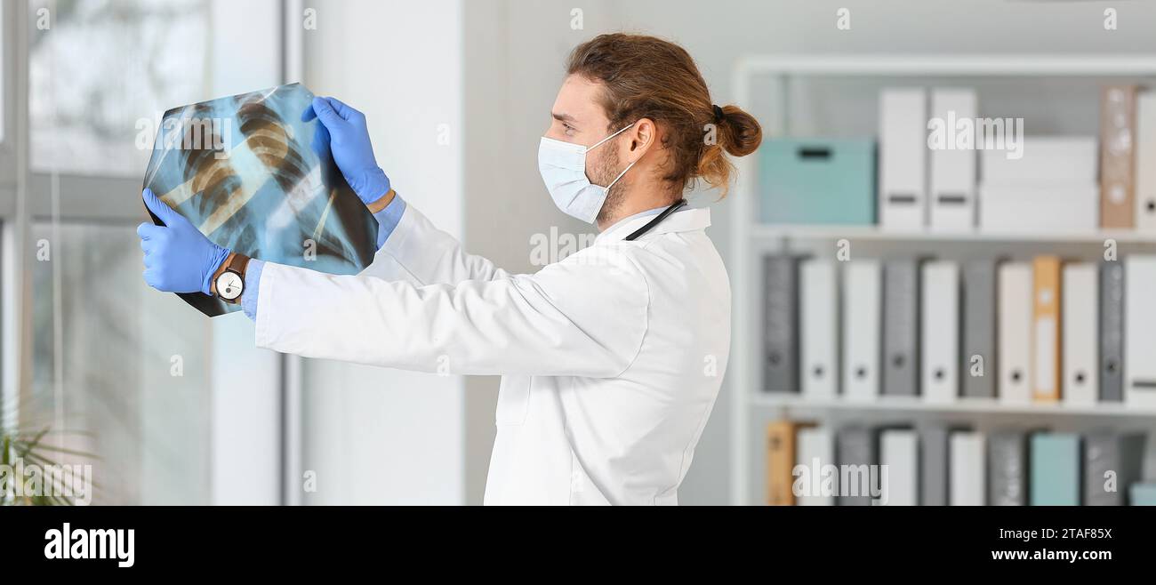 Young male doctor with x-ray image of chest in clinic Stock Photo - Alamy