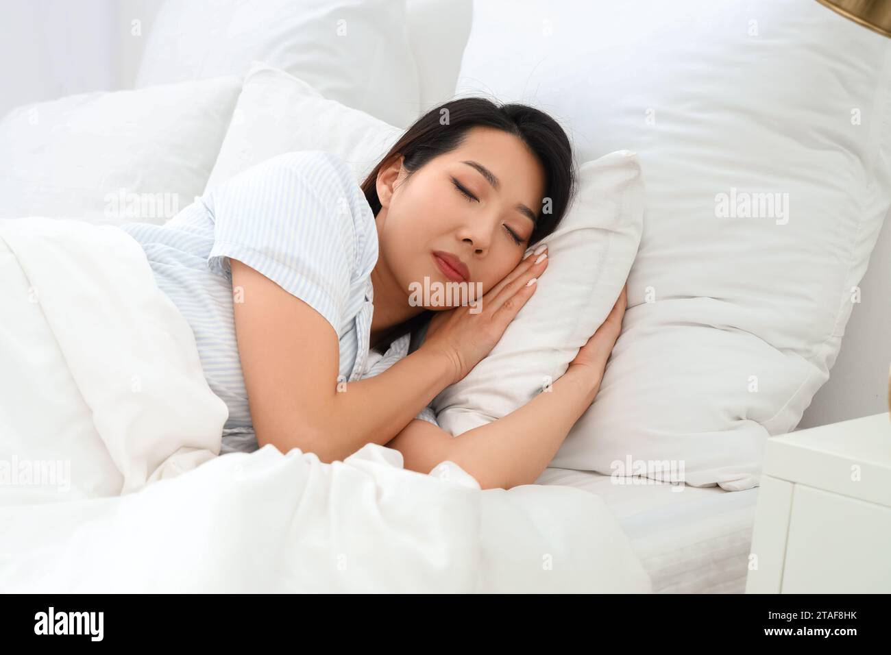 Beautiful Asian woman sleeping in bed Stock Photo - Alamy