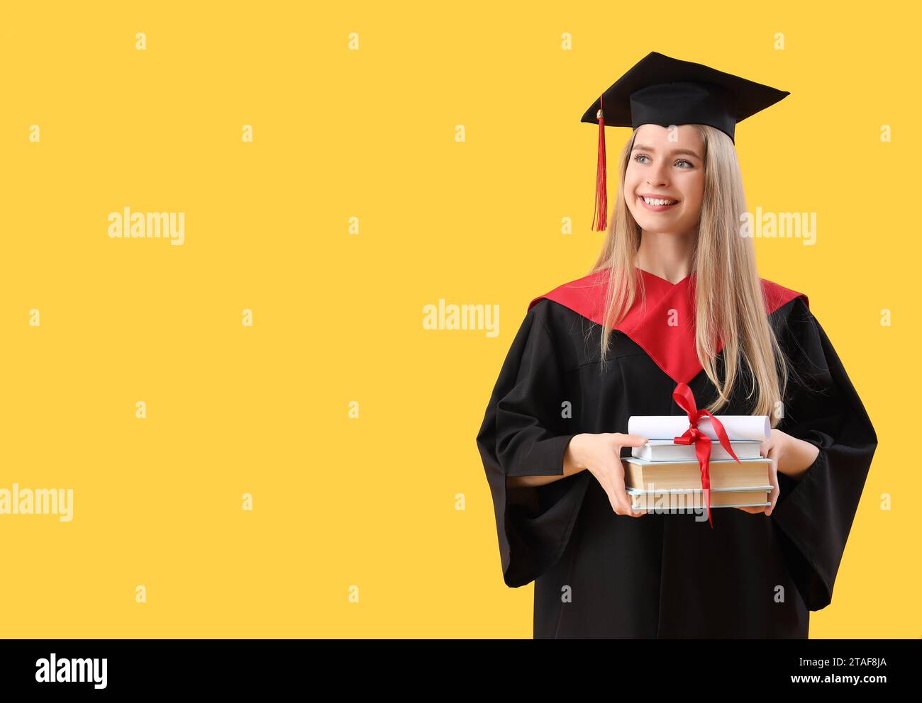 Female graduate student with diploma and books on yellow background ...