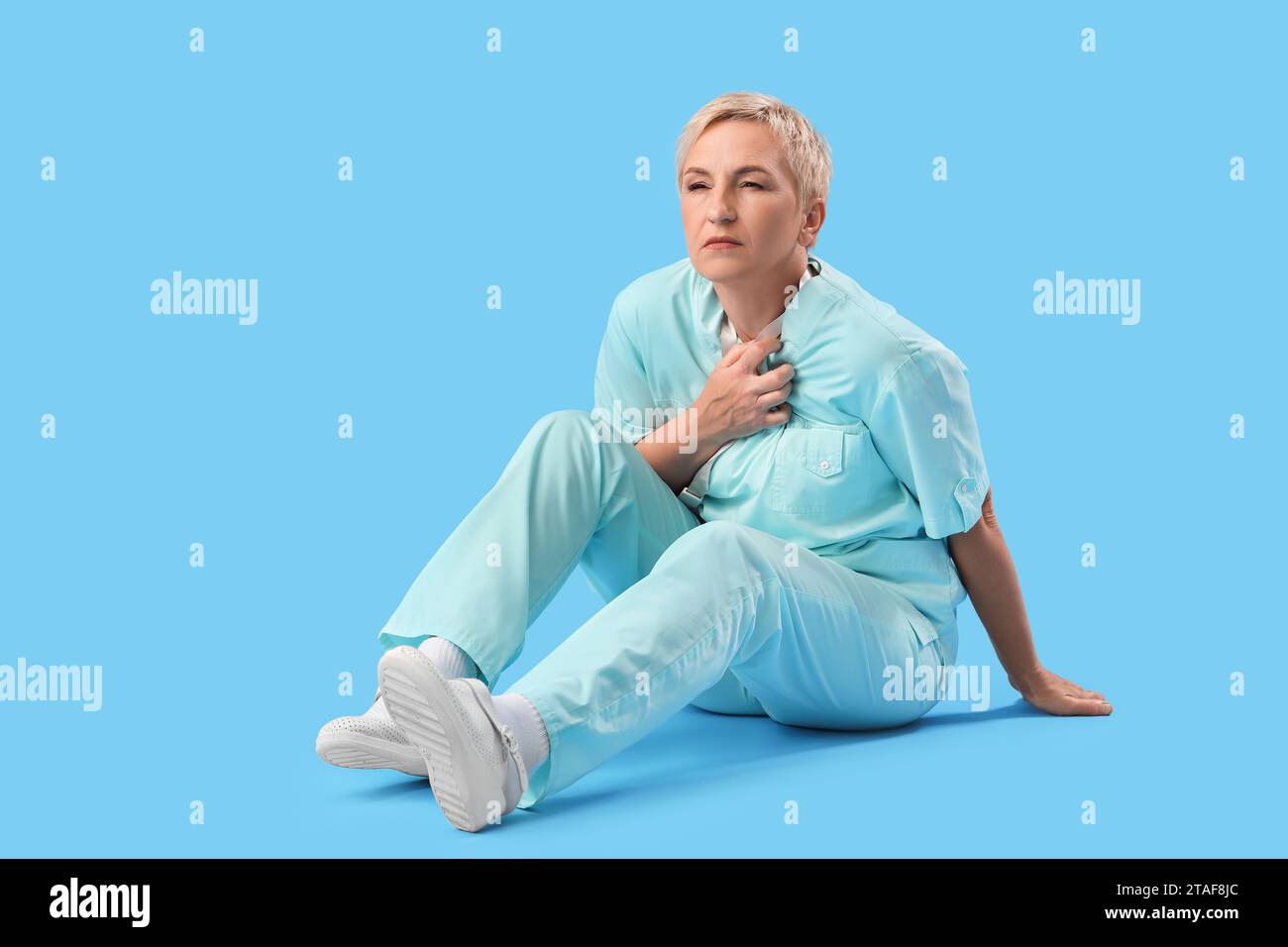 Heart attack aged female sitting hi-res stock photography and images ...