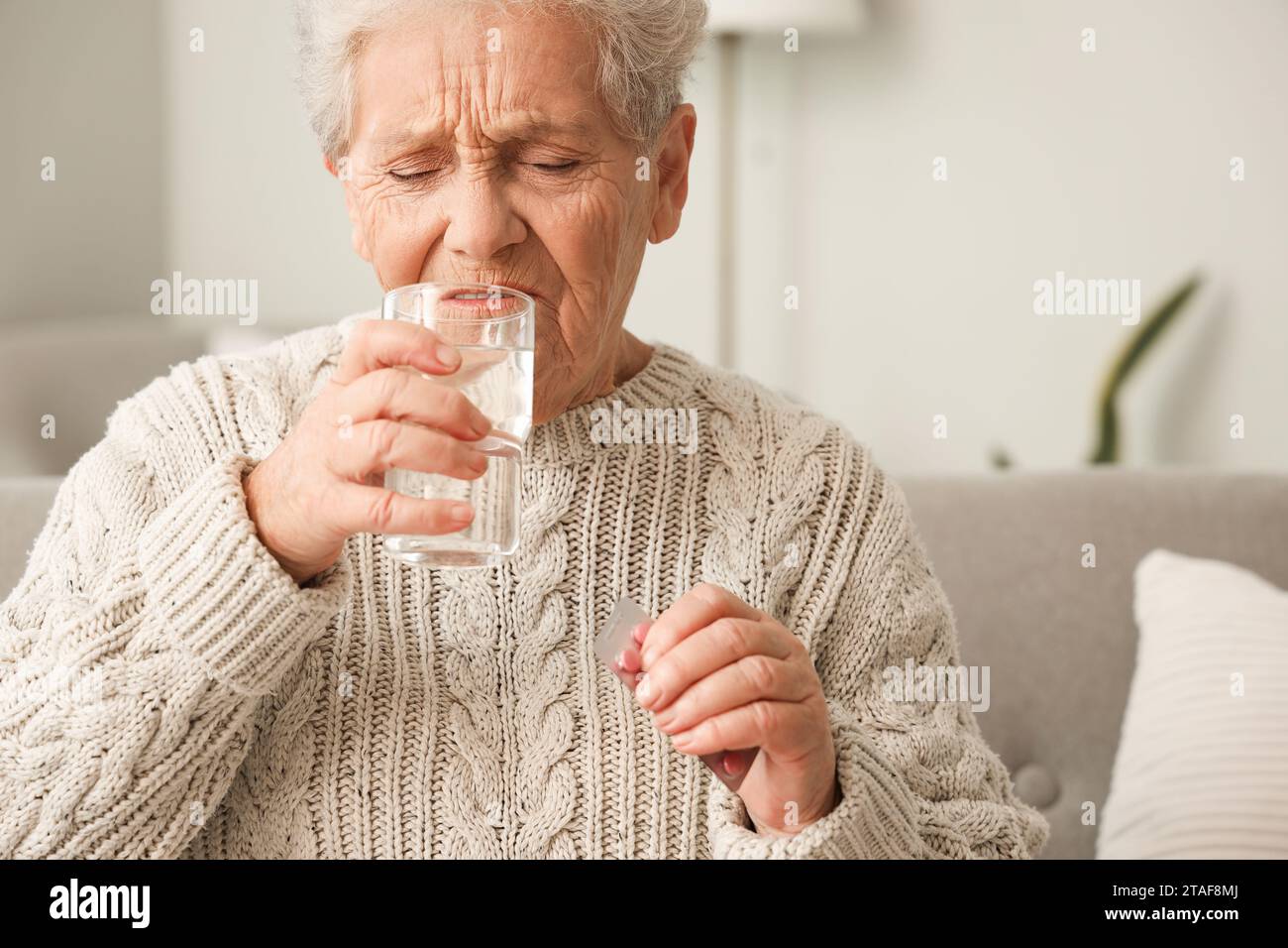 Elderly woman with heart attack taking medicine at home Stock Photo - Alamy