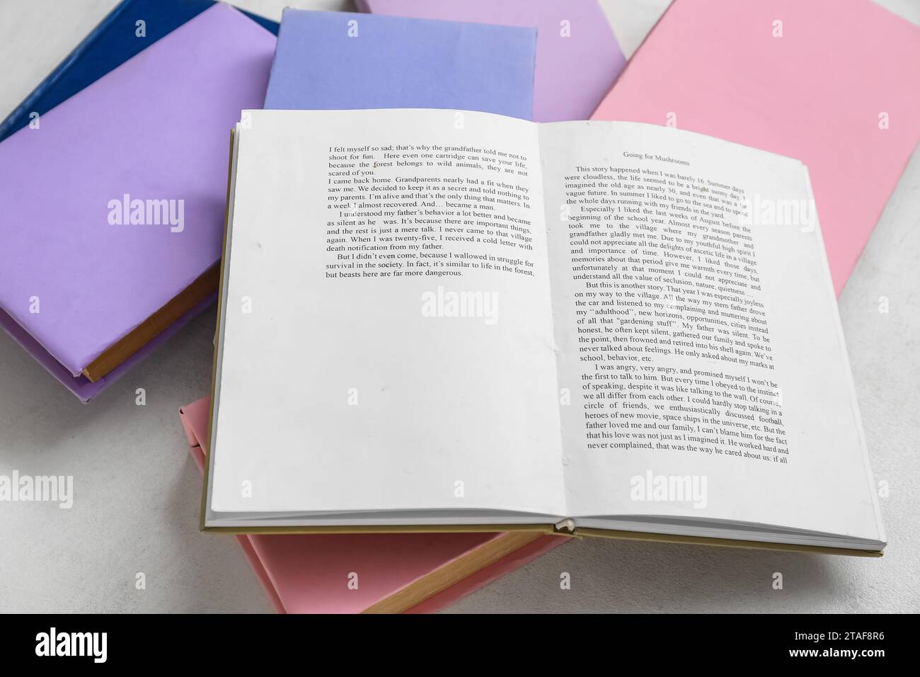 Open and closed books on white table Stock Photo - Alamy