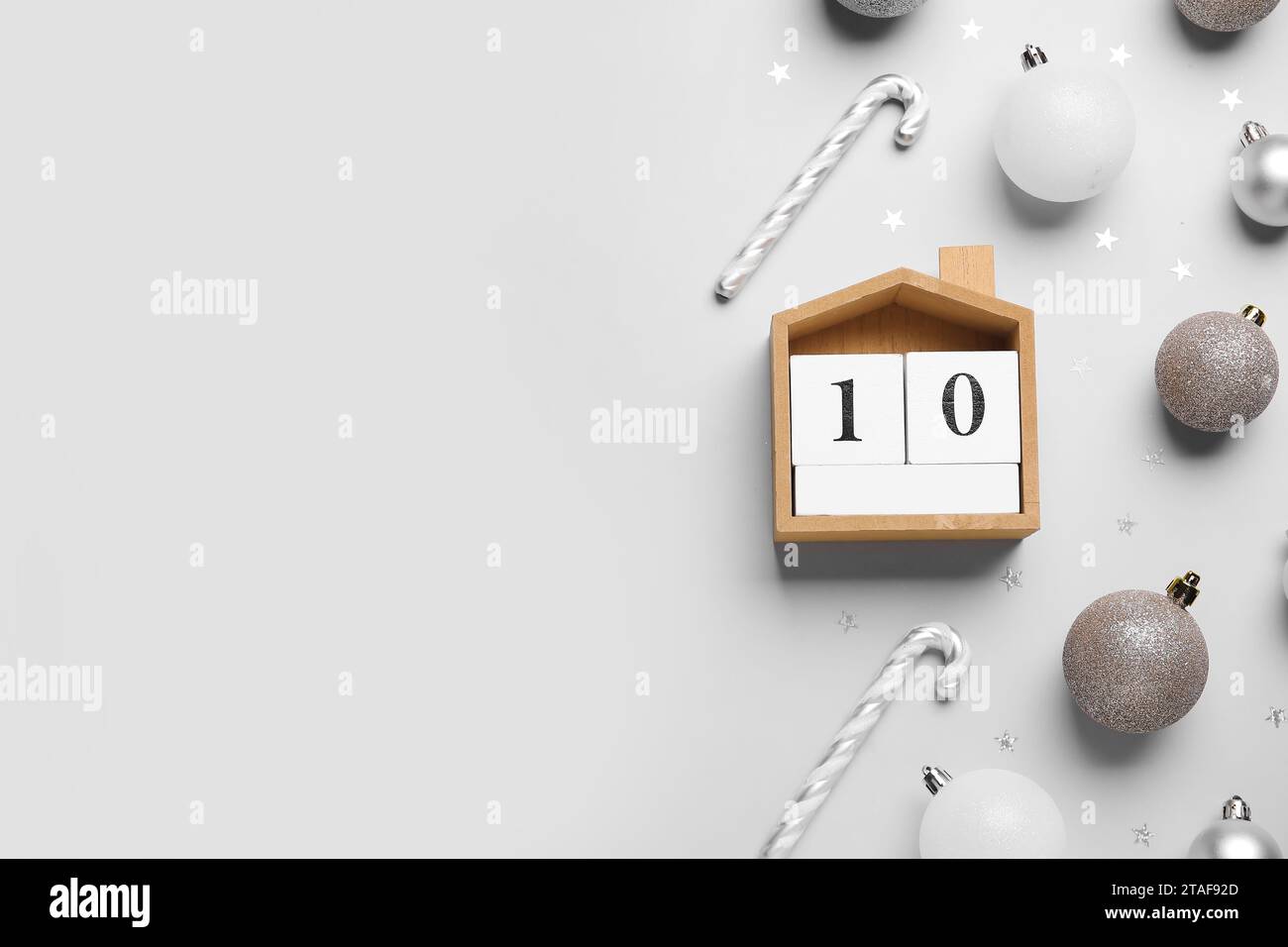 Calendar with text 10 DAYS UNTIL HOLIDAYS and Christmas decor on white ...