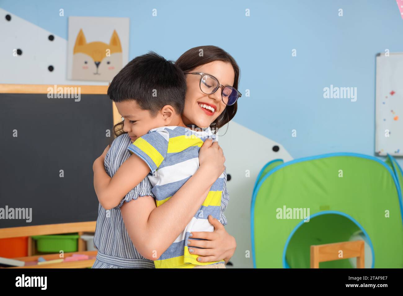 Child hugging teacher hi-res stock photography and images - Alamy