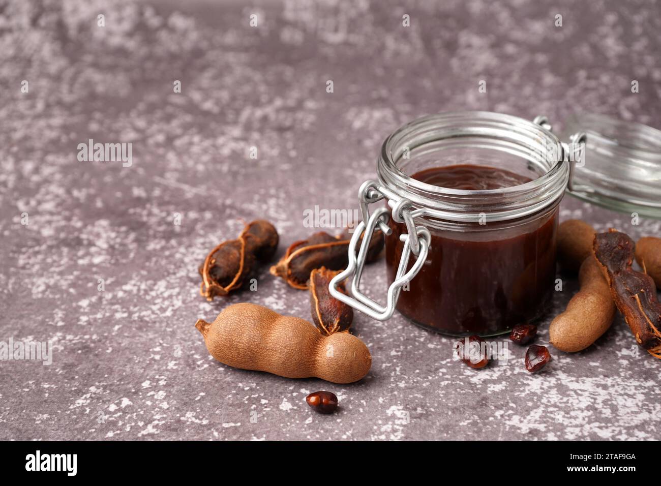 Jar with tasty tamarind jam and fruits on grey background Stock Photo ...