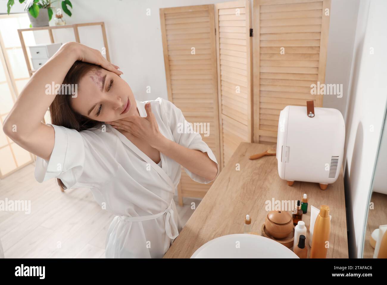 Young woman doing face building exercise in bathroom Stock Photo - Alamy