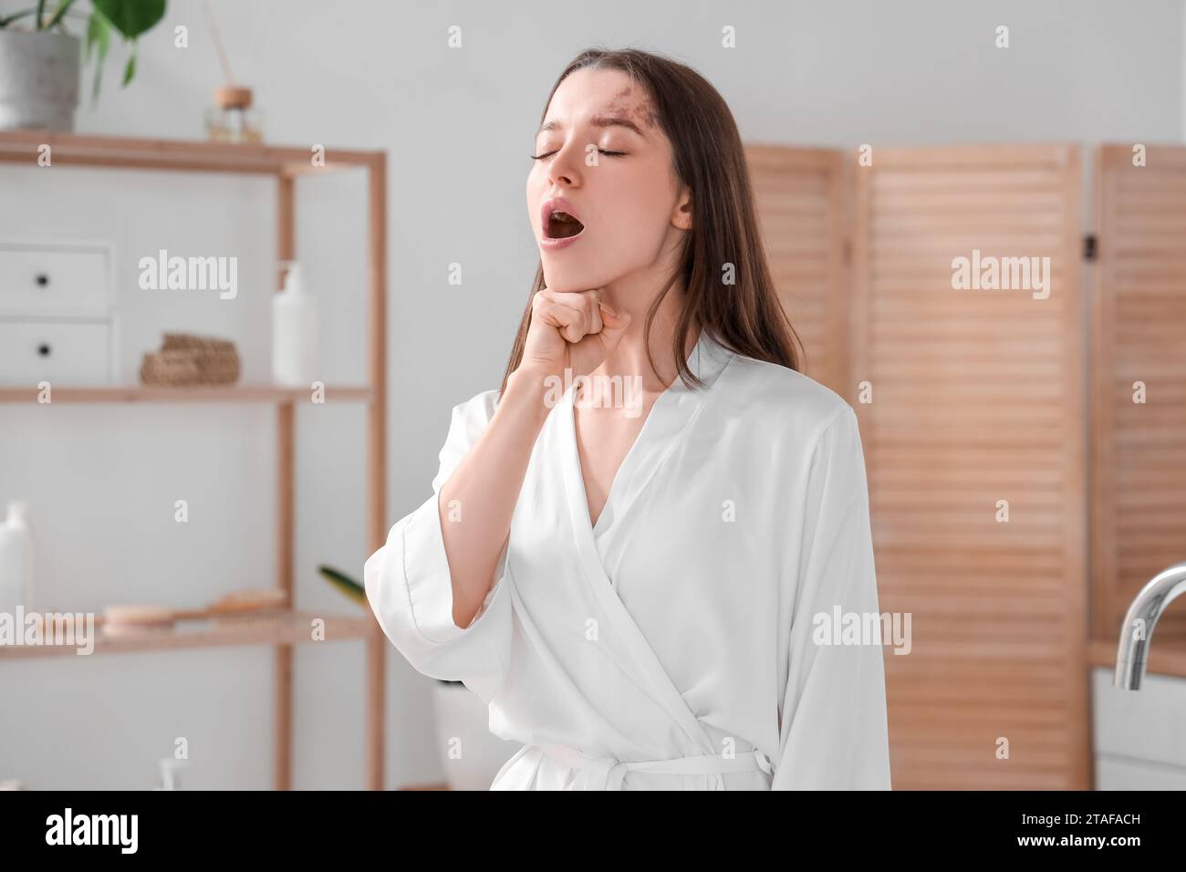 Young woman doing face building exercise in bathroom Stock Photo - Alamy