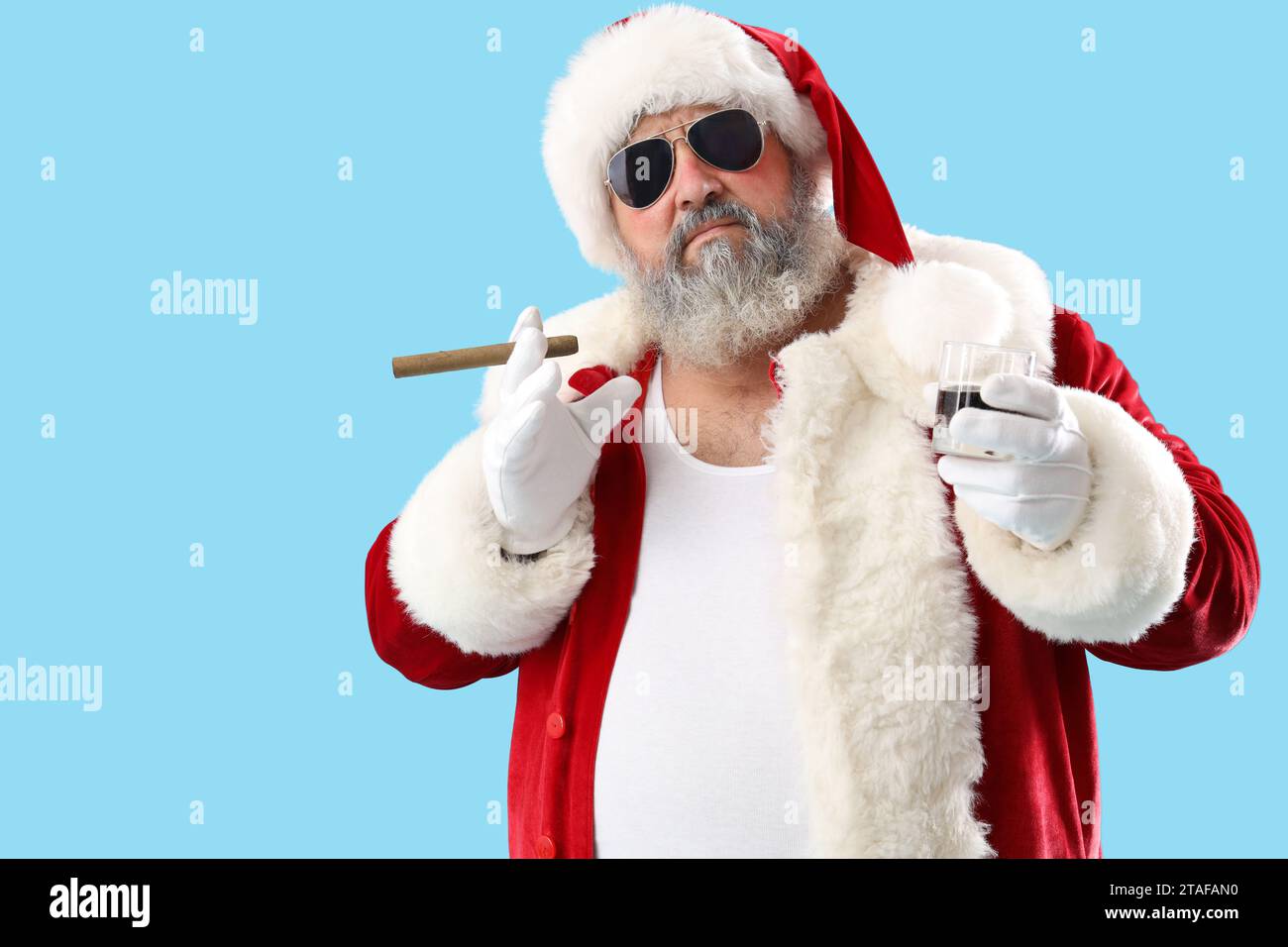 Bad Santa Claus with cigar and whiskey on blue background Stock Photo ...