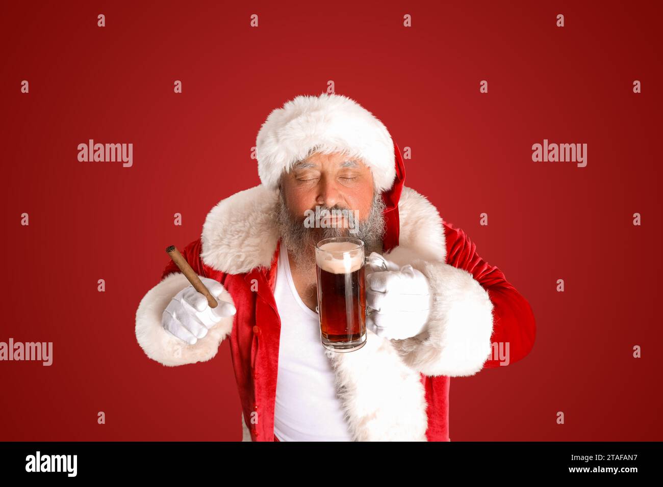 Bad Santa Claus with cigar drinking beer on red background Stock Photo ...