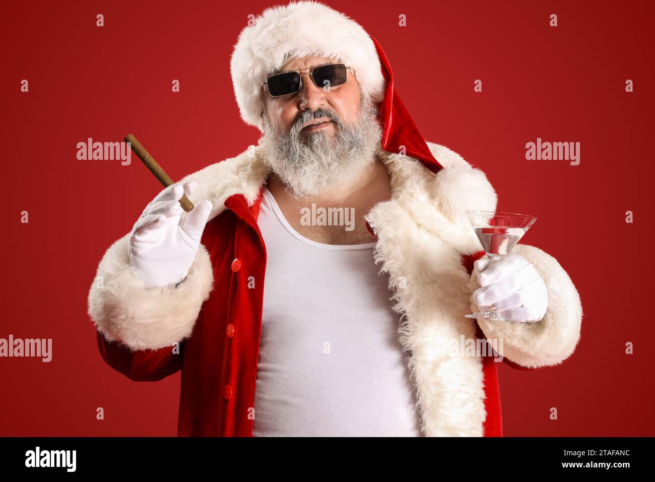 Bad Santa Claus with cigar and cocktail on red background Stock Photo ...