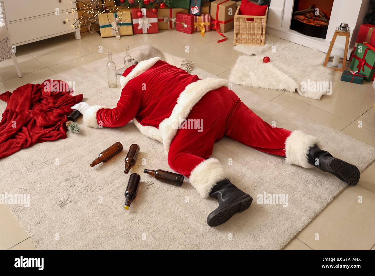 Drunk Santa Claus lying on floor at Christmas party Stock Photo - Alamy