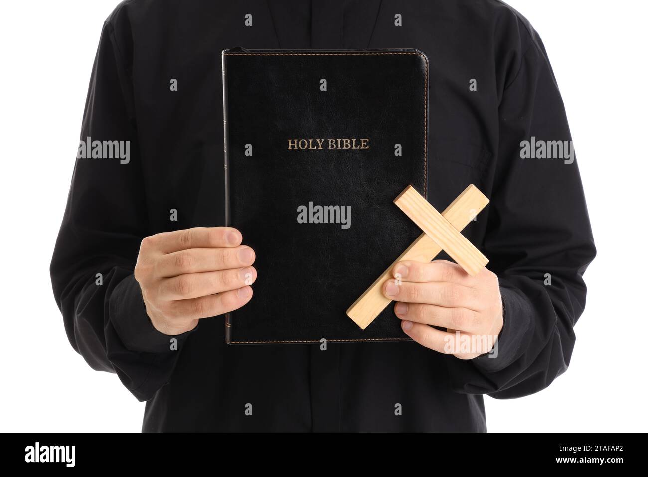 Young priest with cross and Holy Bible on white background, closeup ...