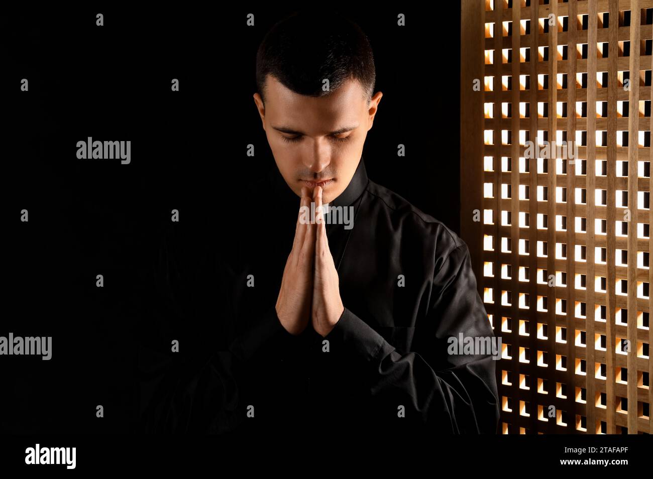 Young catholic priest in black hi-res stock photography and images - Alamy