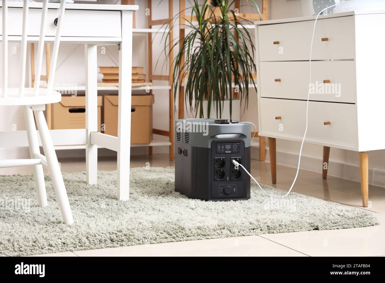 Portable power station with charging phone on floor in contemporary ...