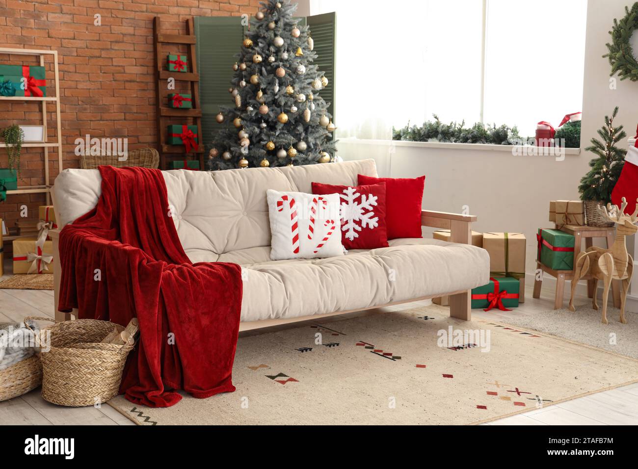 Interior of festive living room with cozy white sofa and Christmas ...