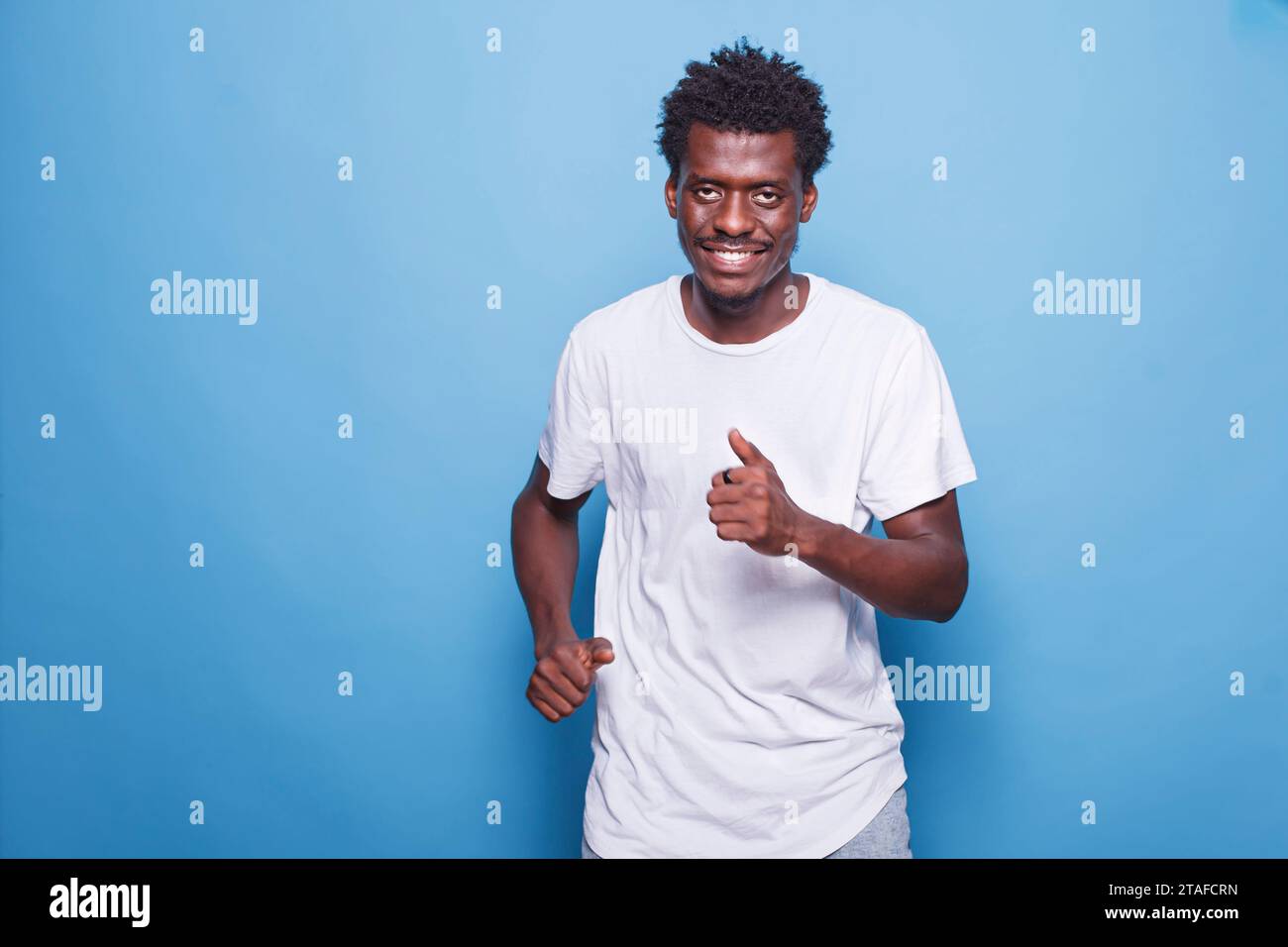 Cheerful african american male individual dancing and posing while ...
