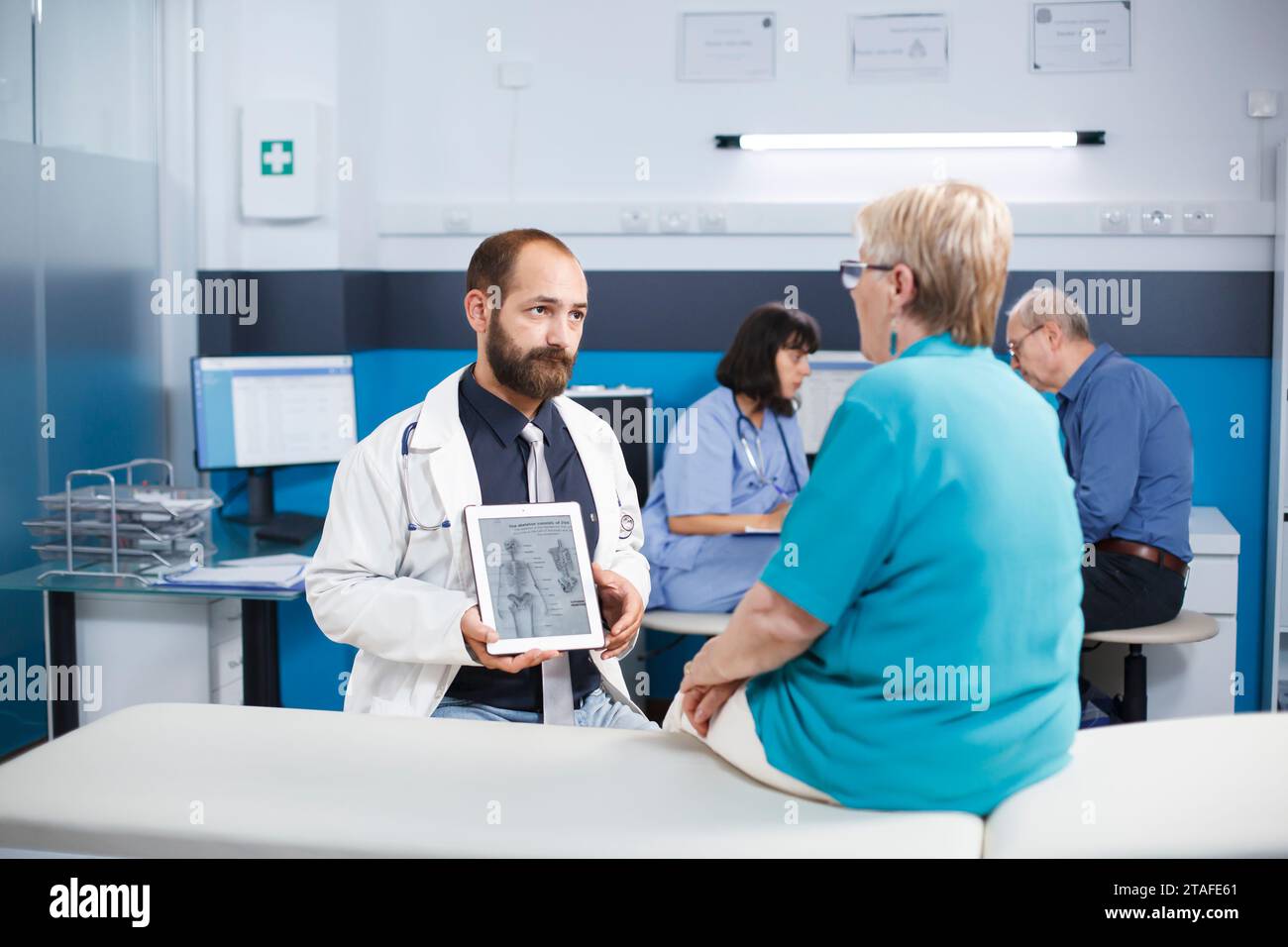 During medical checkup, healthcare specialist shows picture of human ...