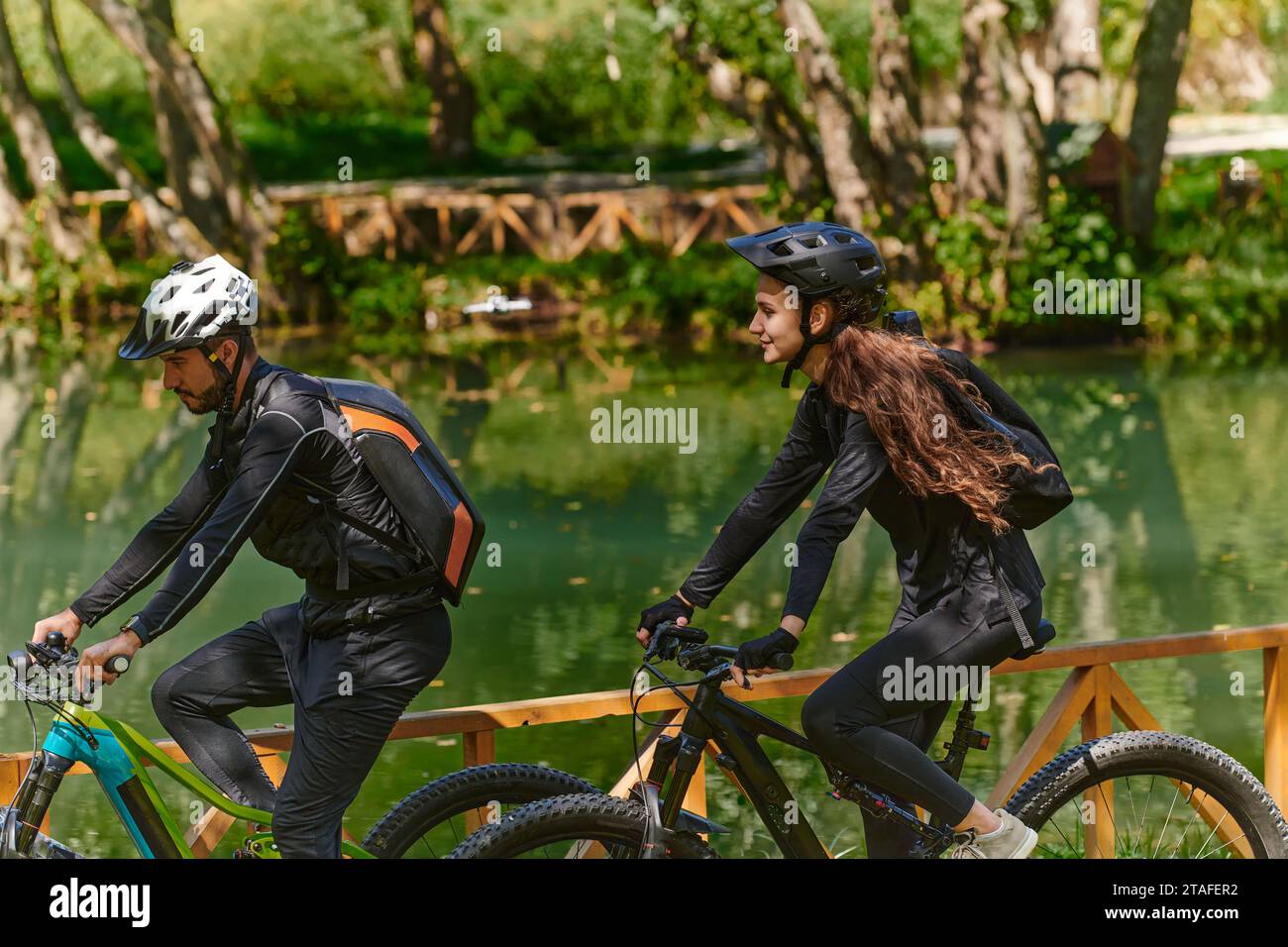 A blissful couple, adorned in professional cycling gear, enjoys a ...