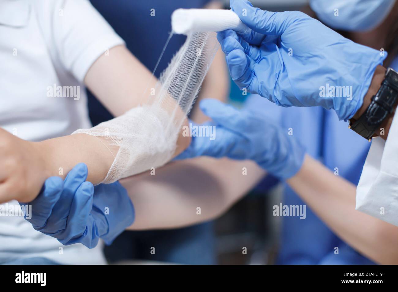 Close-up shot of a wound on the arm of a patient being carefully ...