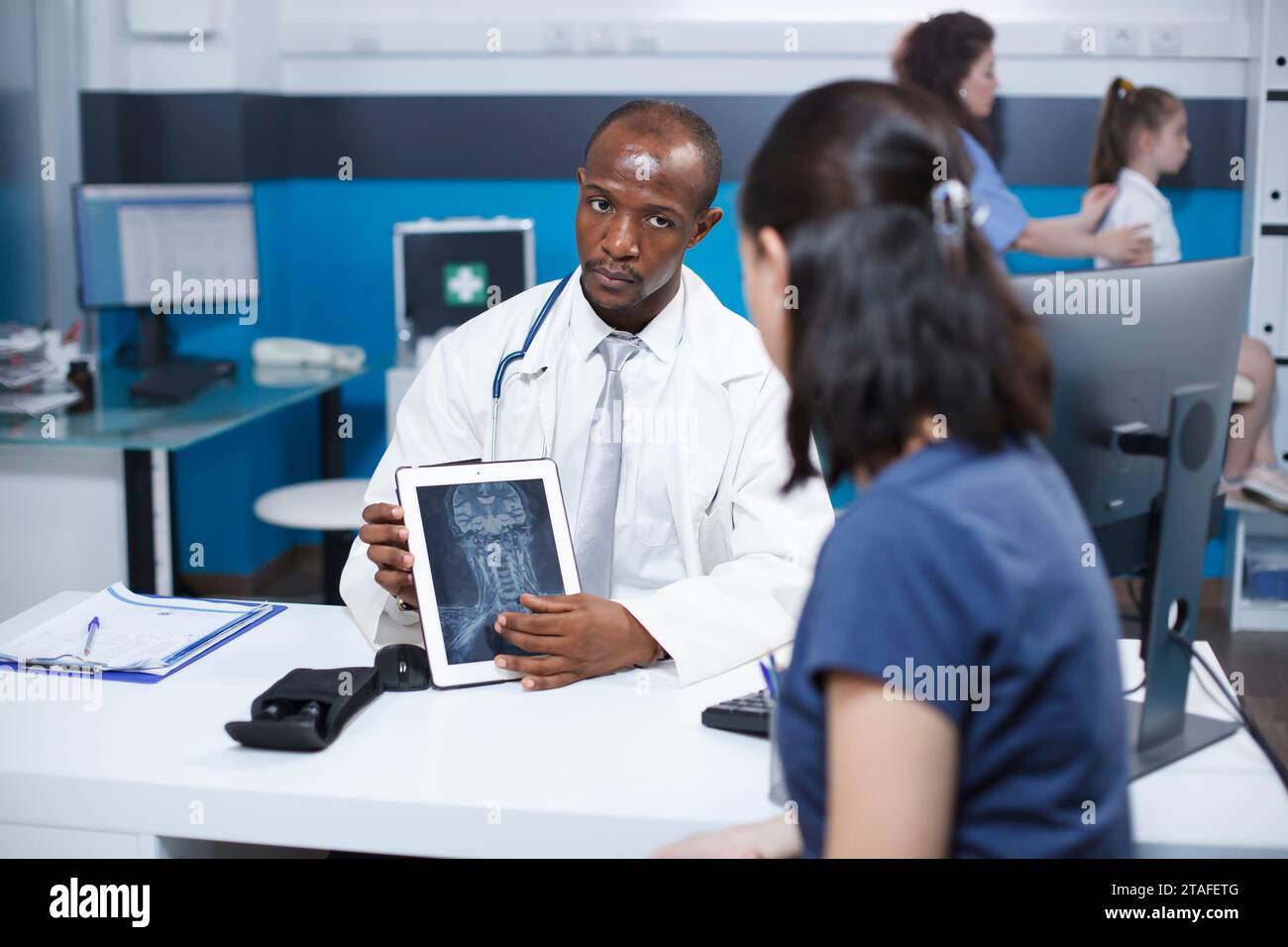 Doctor discussing x-ray scan of cervical spine injury diagnosis results ...