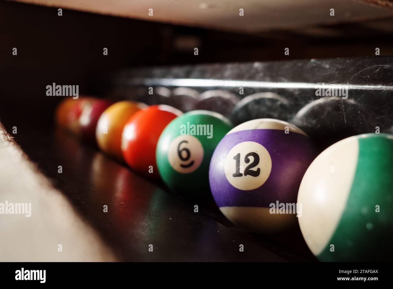 Selective focus at pool billiards ball on the cabinet side of pool ...