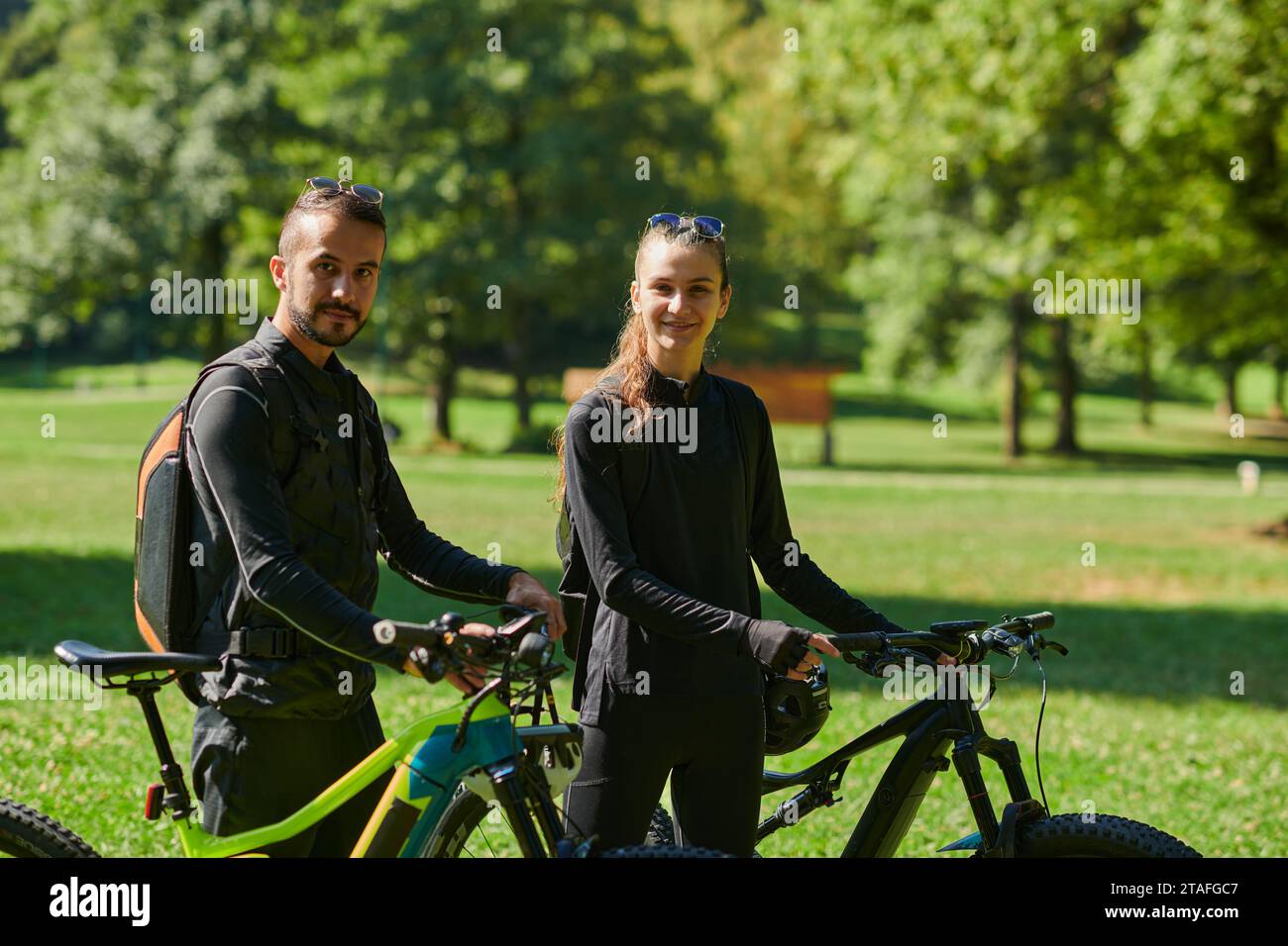 A blissful couple, adorned in professional cycling gear, enjoys a ...