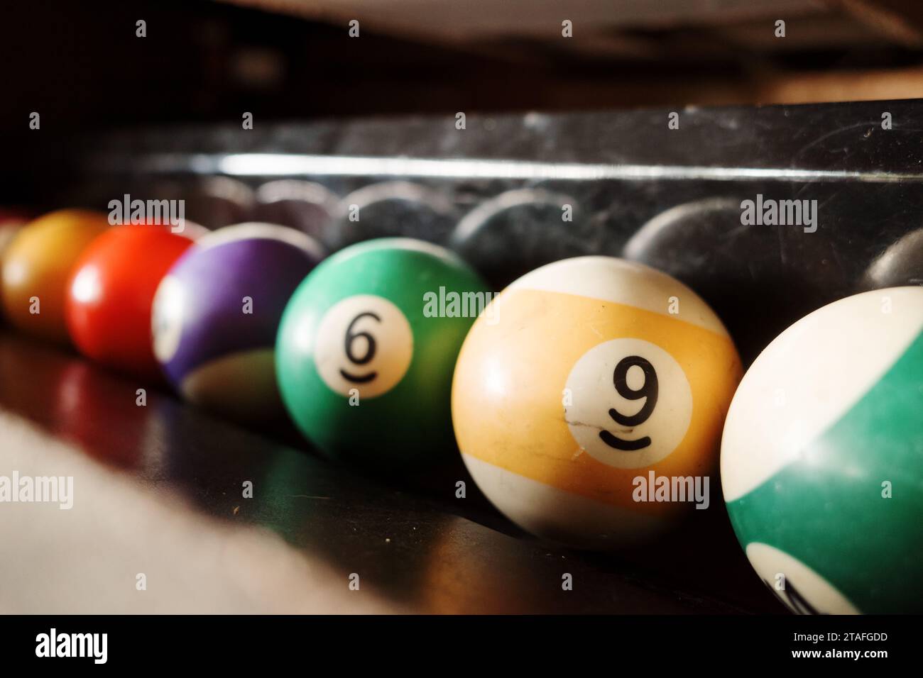Selective focus at pool billiards ball on the cabinet side of pool ...