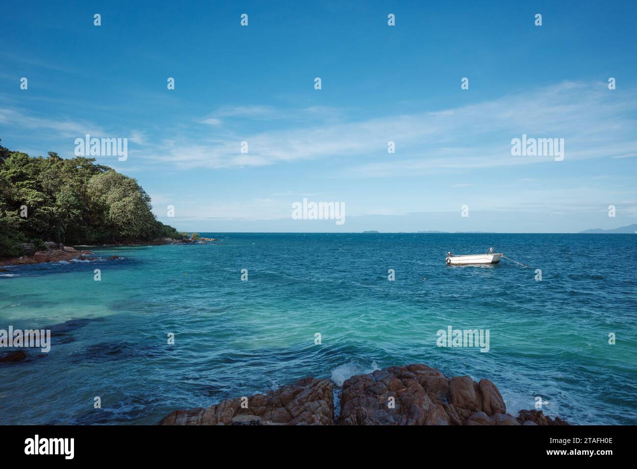 Outdoor scenery view of small boat anchoring and sea waves with clear ...