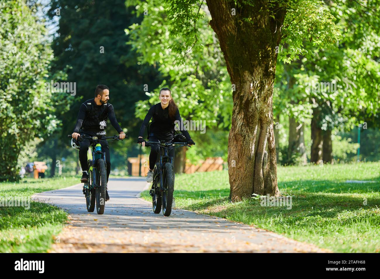 A blissful couple, adorned in professional cycling gear, enjoys a ...