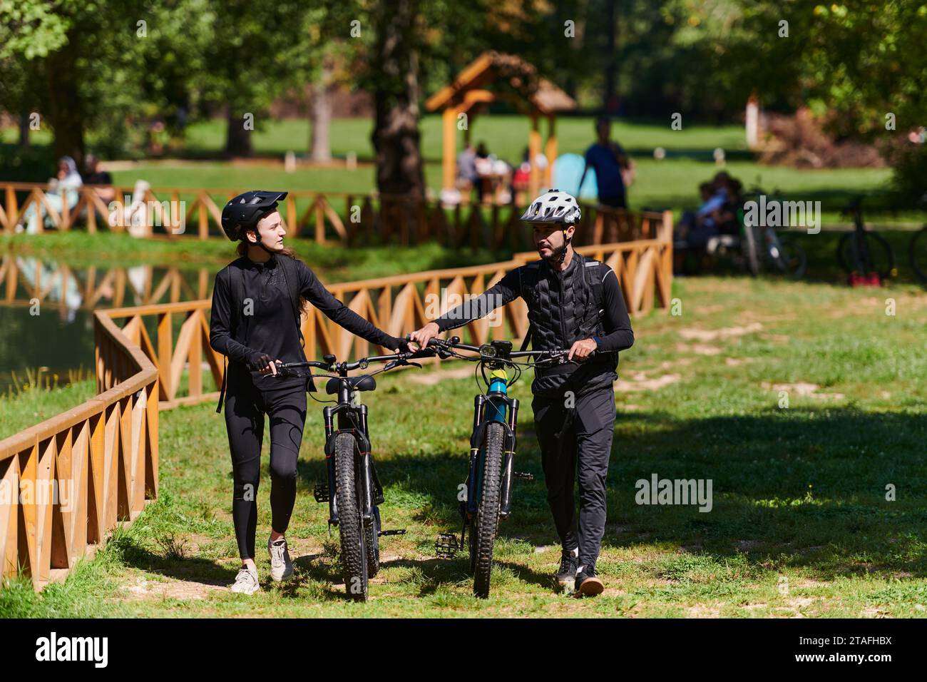 A blissful couple, adorned in professional cycling gear, enjoys a ...