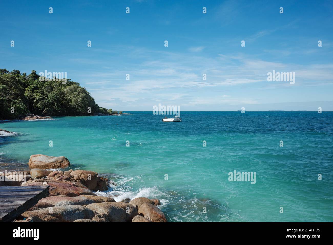 Outdoor scenery view of small boat anchoring and sea waves with clear ...